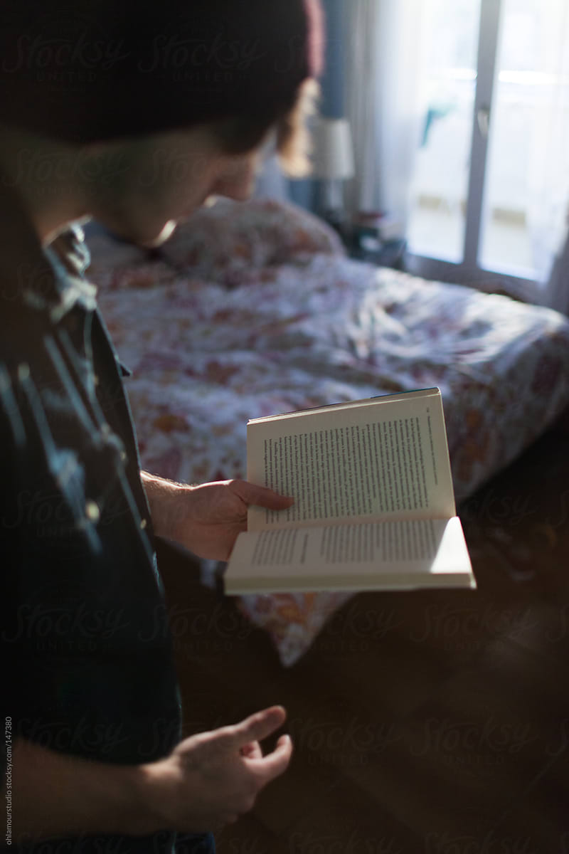 "Man Reading A Book" by Stocksy Contributor "Leandro Crespi" - Stocksy