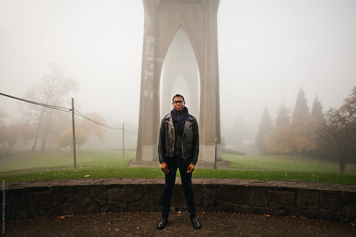 "Portrait Of A Man Standing Under A Bridge With Autumn Colored Trees In ...