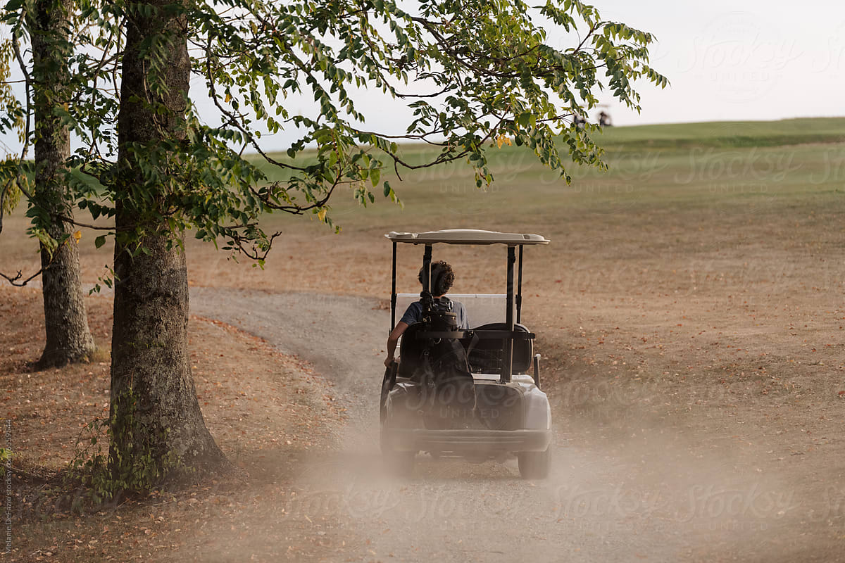 "Teenage Boy Golfing" by Stocksy Contributor "Melanie DeFazio" - Stocksy