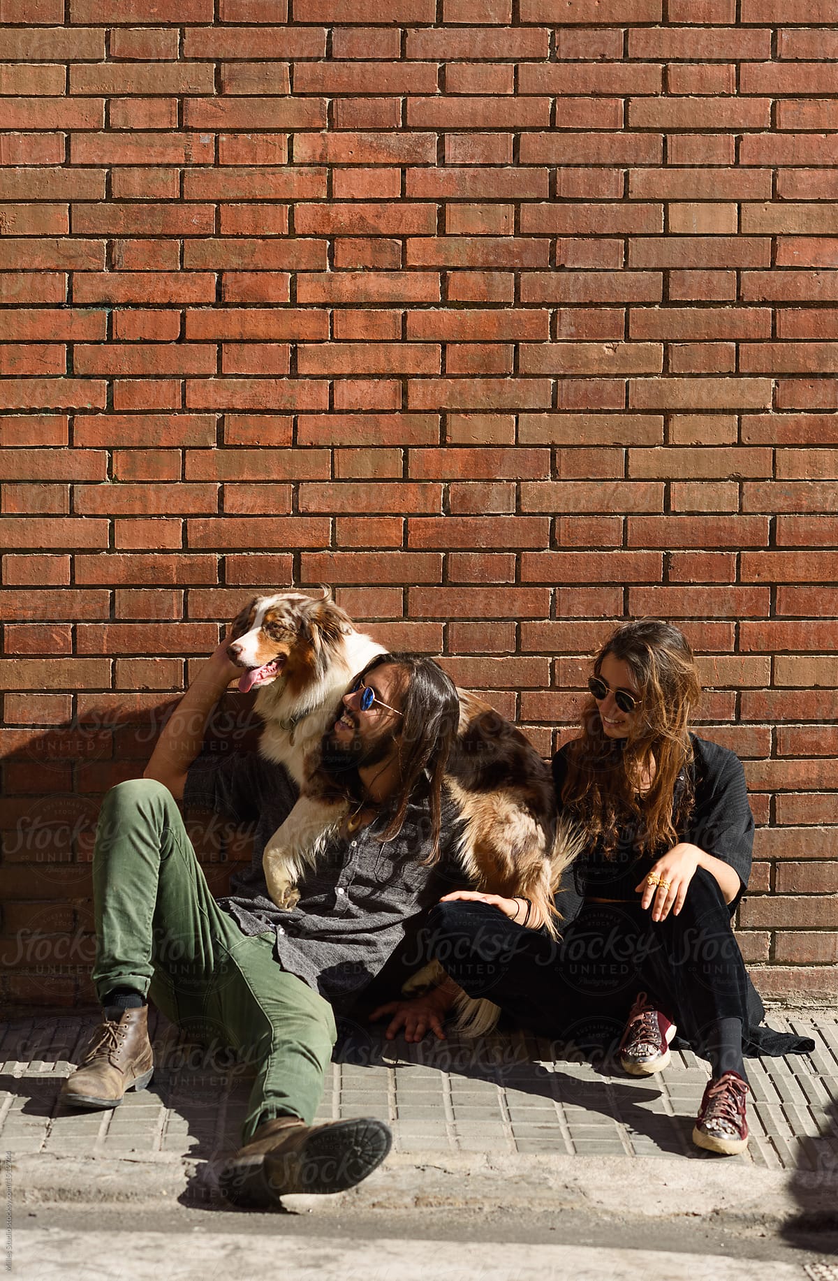 "Couple With Dog At Brick Wall" by Stocksy Contributor "Milles Team ...