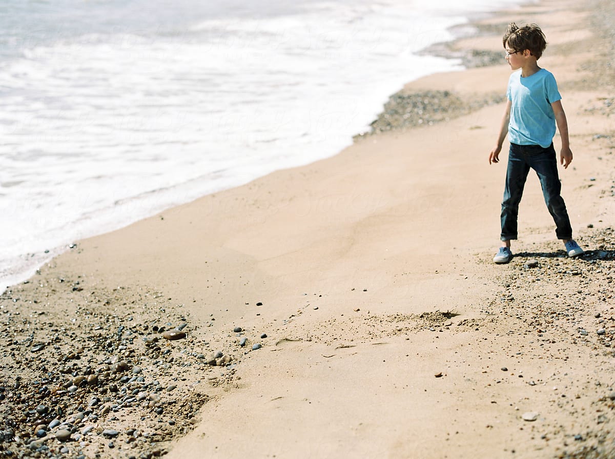 "Boy Standing On The Beach And Looking At The Sea" by Stocksy ...