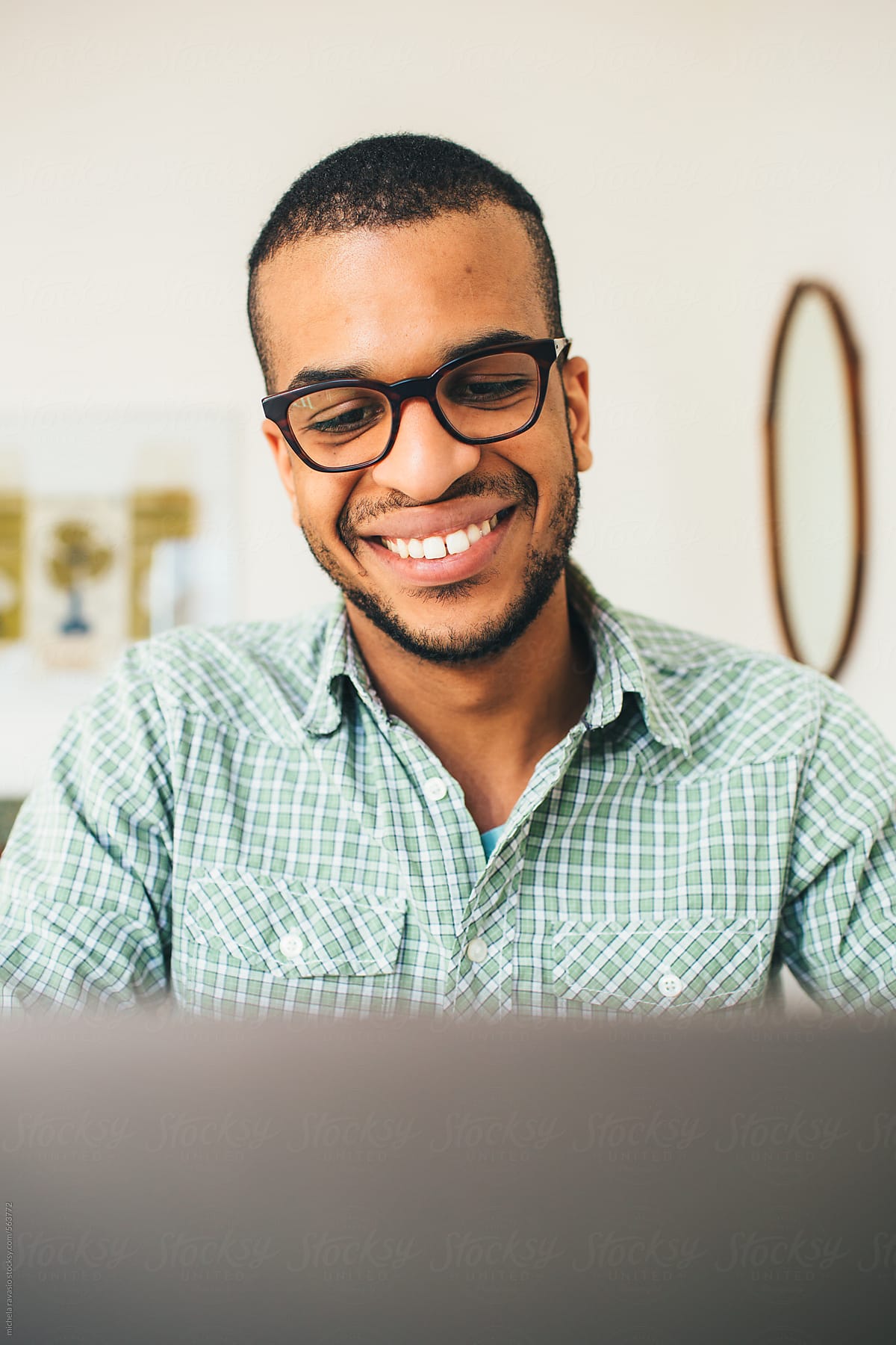 "Man Smiling At His Laptop" by Stocksy Contributor "Michela Ravasio ...