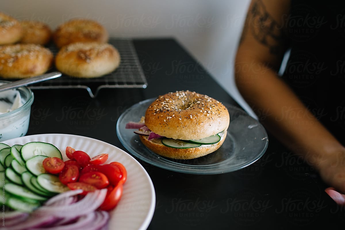 "Woman Making Bagel Sandwich" by Stocksy Contributor "Jennifer Brister ...