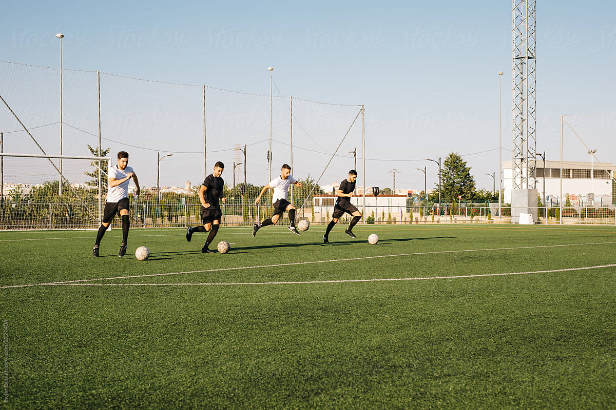 "Four Soccer Player Running" by Stocksy Contributor "Javier Díez" - Stocksy