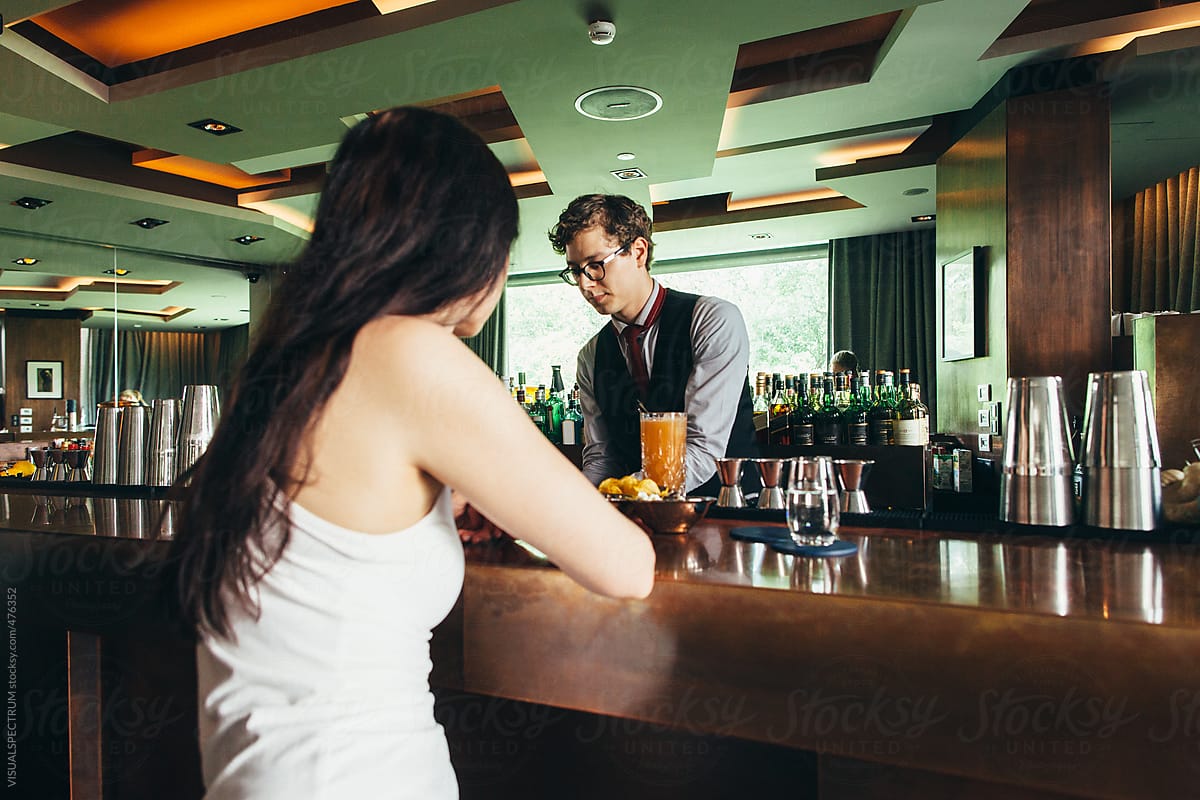 "Young Bartender Preparing Ice Tea For Female Customer" by Stocksy ...