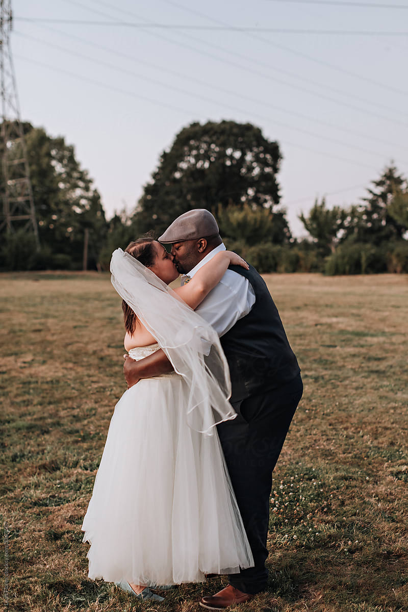Bride And Groom Kissing Sunset