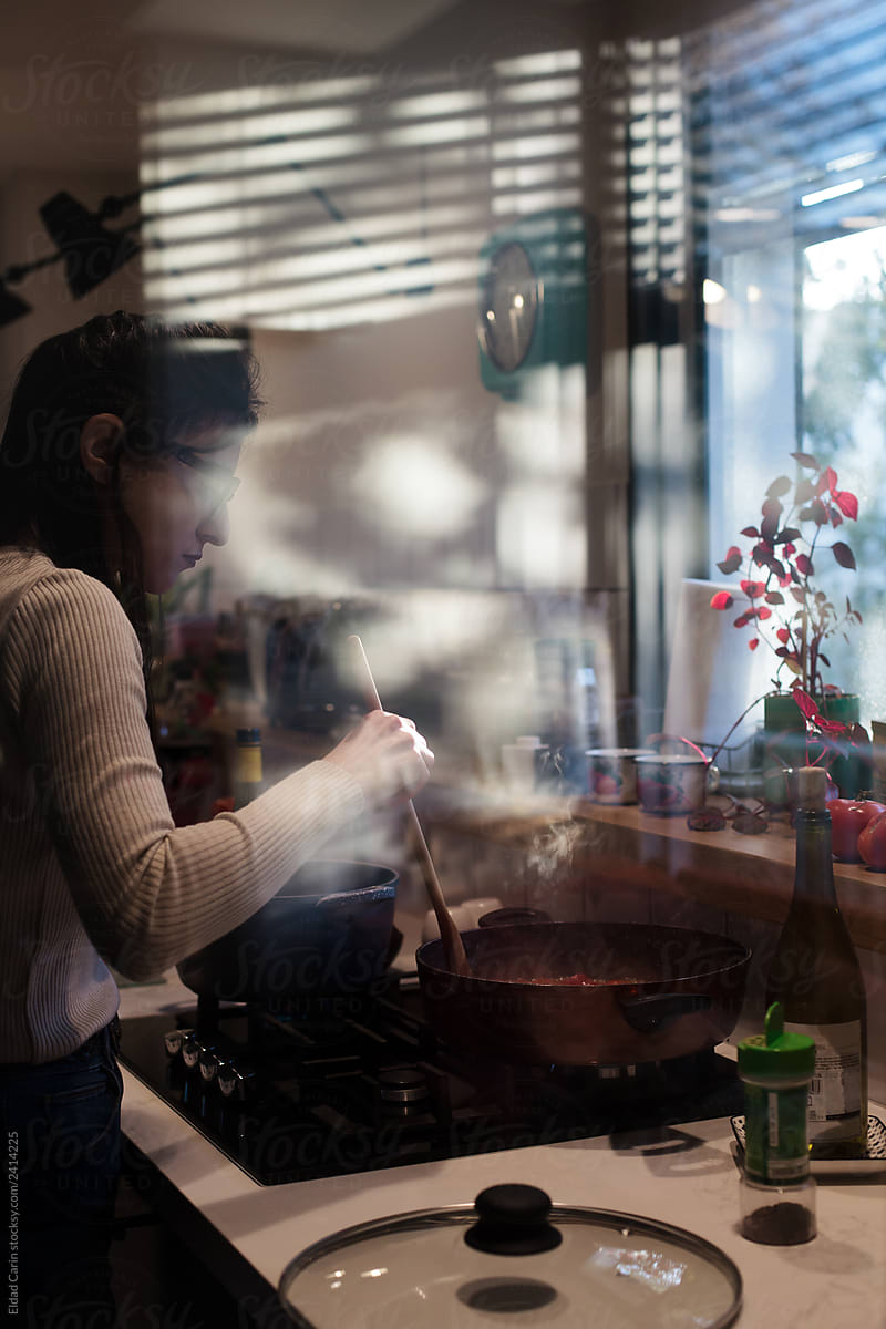 "Woman Cooking At Home" by Stocksy Contributor "Eldad Carin" - Stocksy