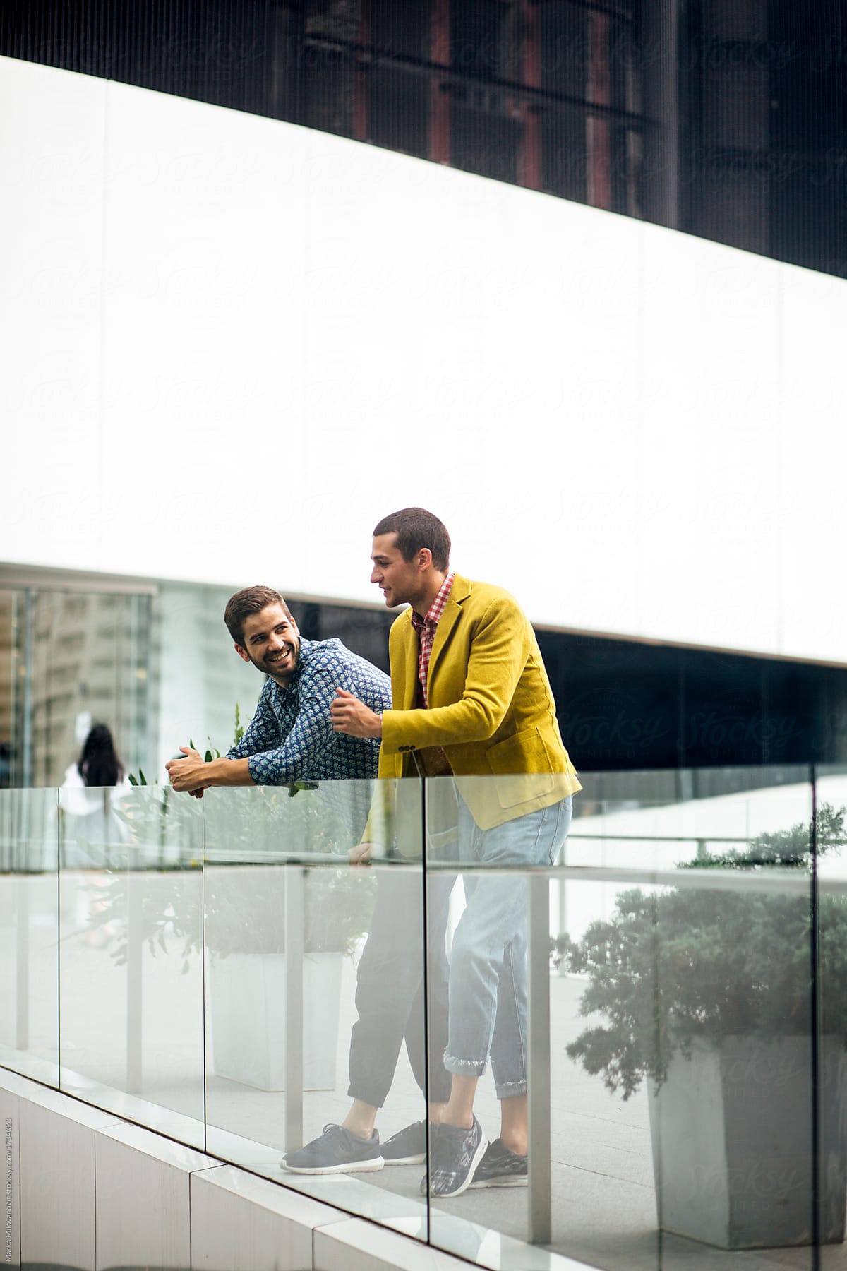 "Men Having A Chat On The Mall Balcony" by Stocksy Contributor "Marko ...