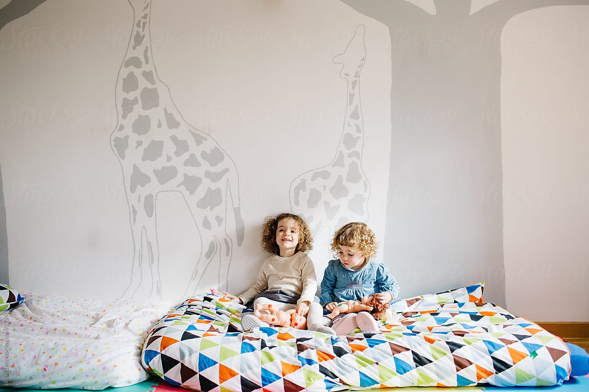 "Smiling Kids On Bed" by Stocksy Contributor "Javier Díez" - Stocksy