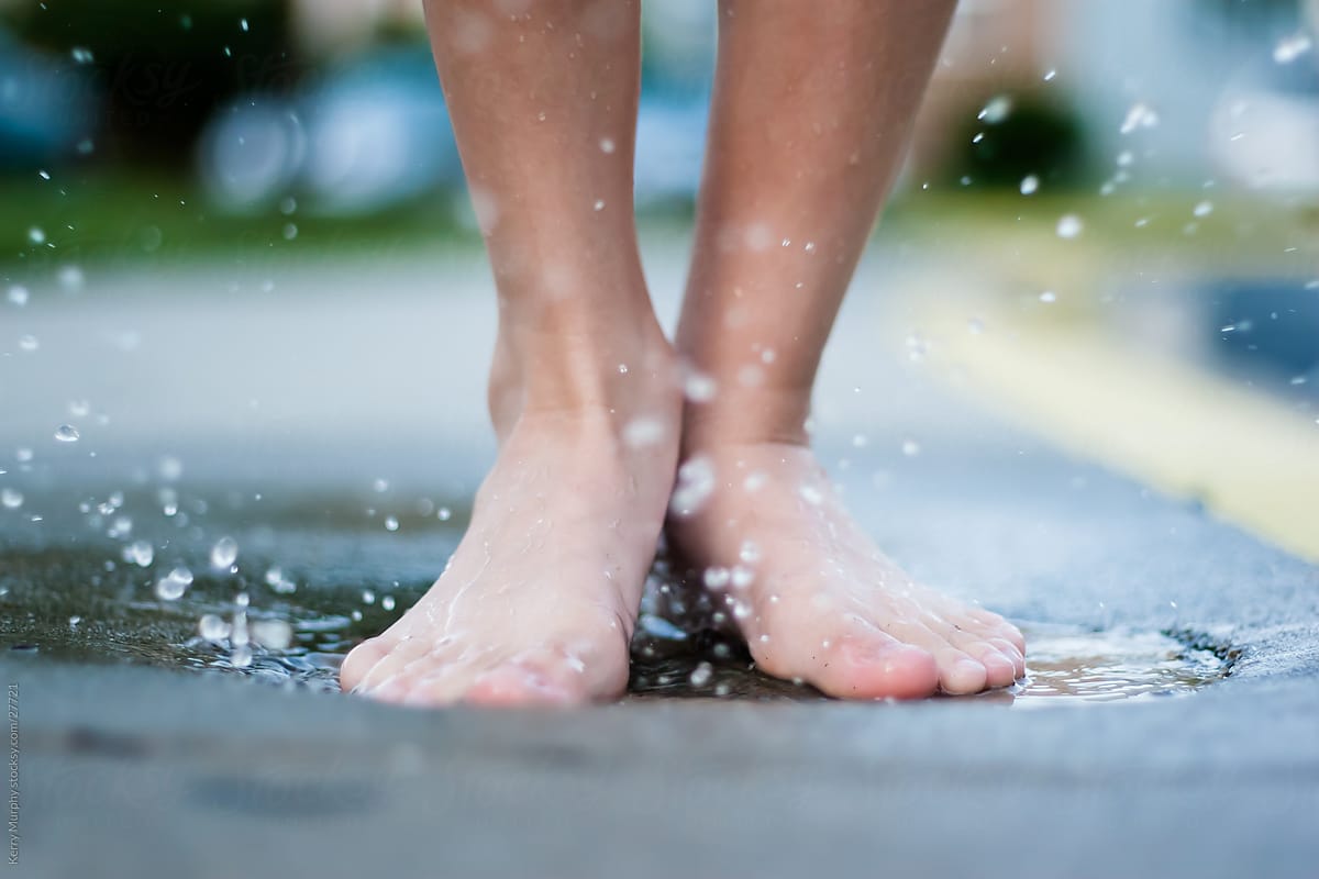 "Child's Feet Splashing In Puddle" by Stocksy Contributor "Kerry Murphy ...