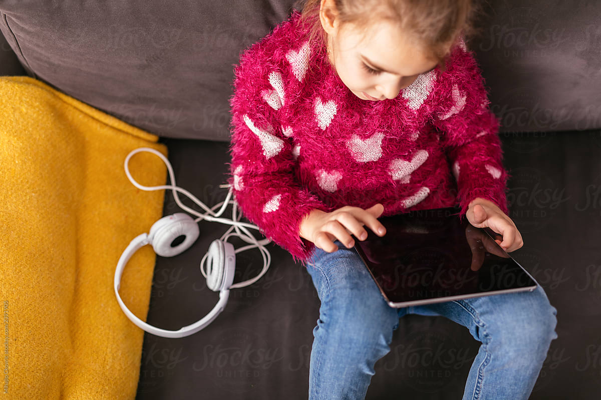 "Cute Girl Using A Tablet" by Stocksy Contributor "Mihajlo Ckovric ...