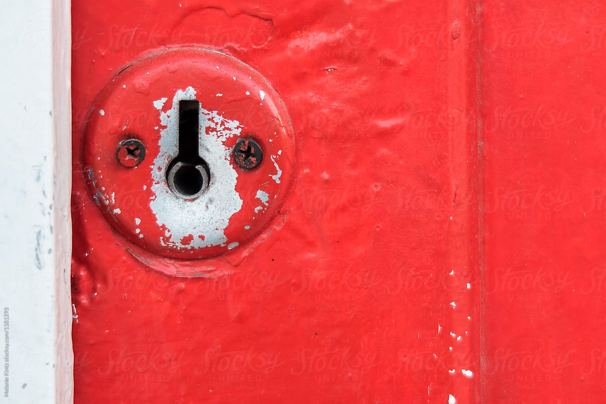 "Red Lock In A Door" by Stocksy Contributor "Melanie Kintz" - Stocksy