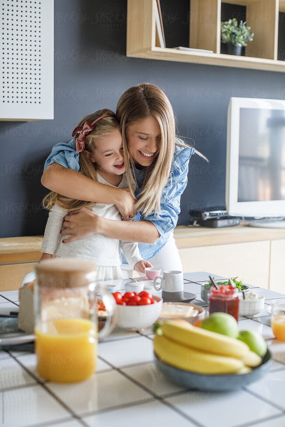 "Mother Cuddling Her Child" by Stocksy Contributor "Lumina" - Stocksy