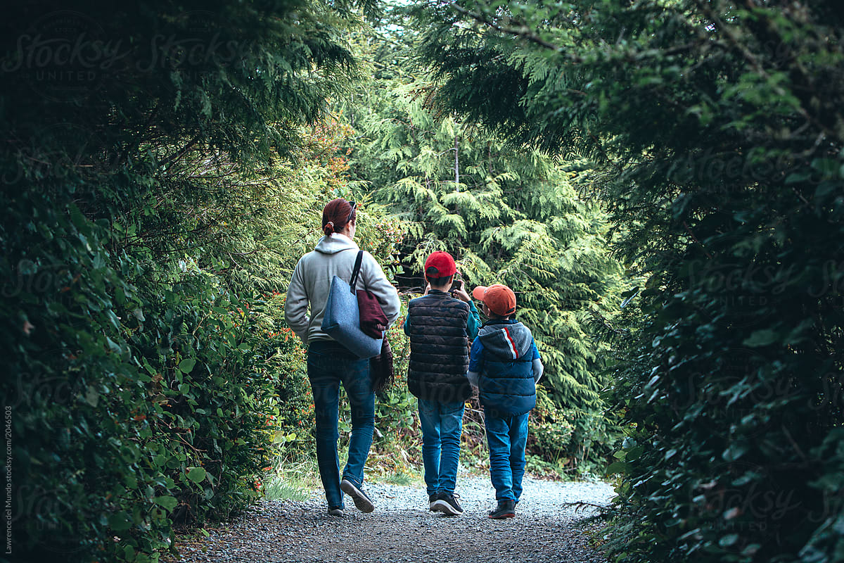 "Mother And Sons Taking A Leisurely Walk Along A Trail In The Pacific ...