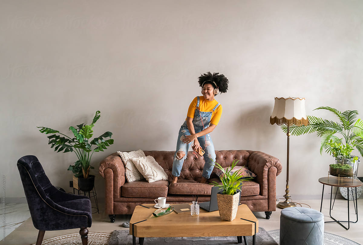 "Woman Dancing On Sofa At Home" by Stocksy Contributor "Hernandez ...