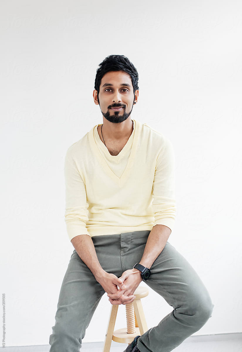 "Portrait Of A Young Man Sitting On A Stool." by Stocksy Contributor ...