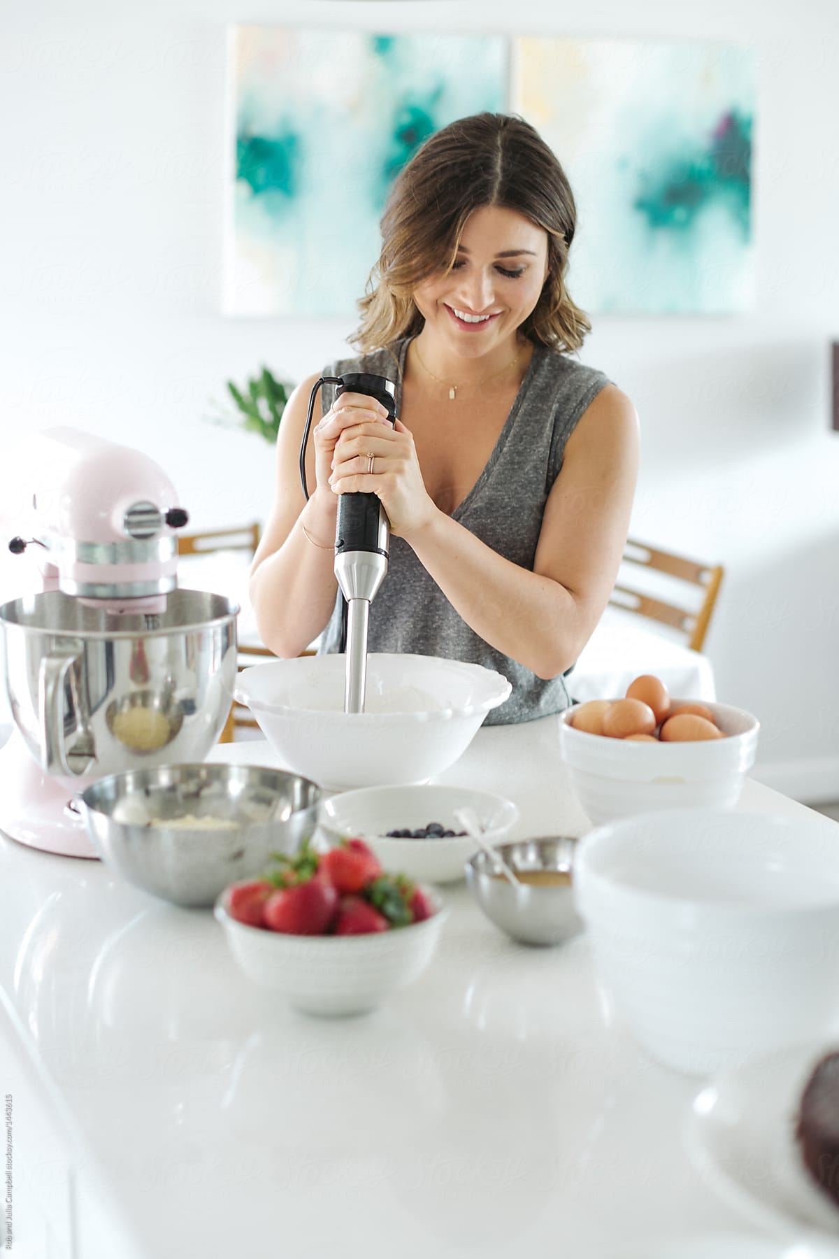 "Woman Blending Coconut Cream Icing" by Stocksy Contributor "Rob And ...