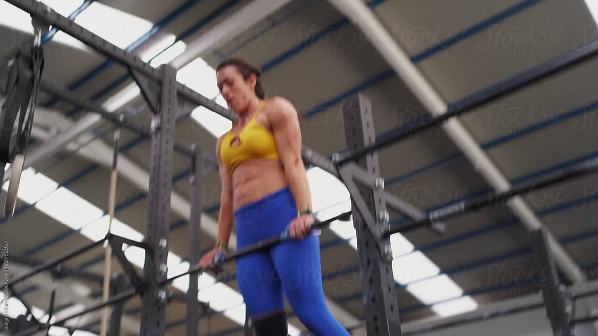 "Strong Woman Doing Bar Muscle Ups In Crossfit Training" by Stocksy ...