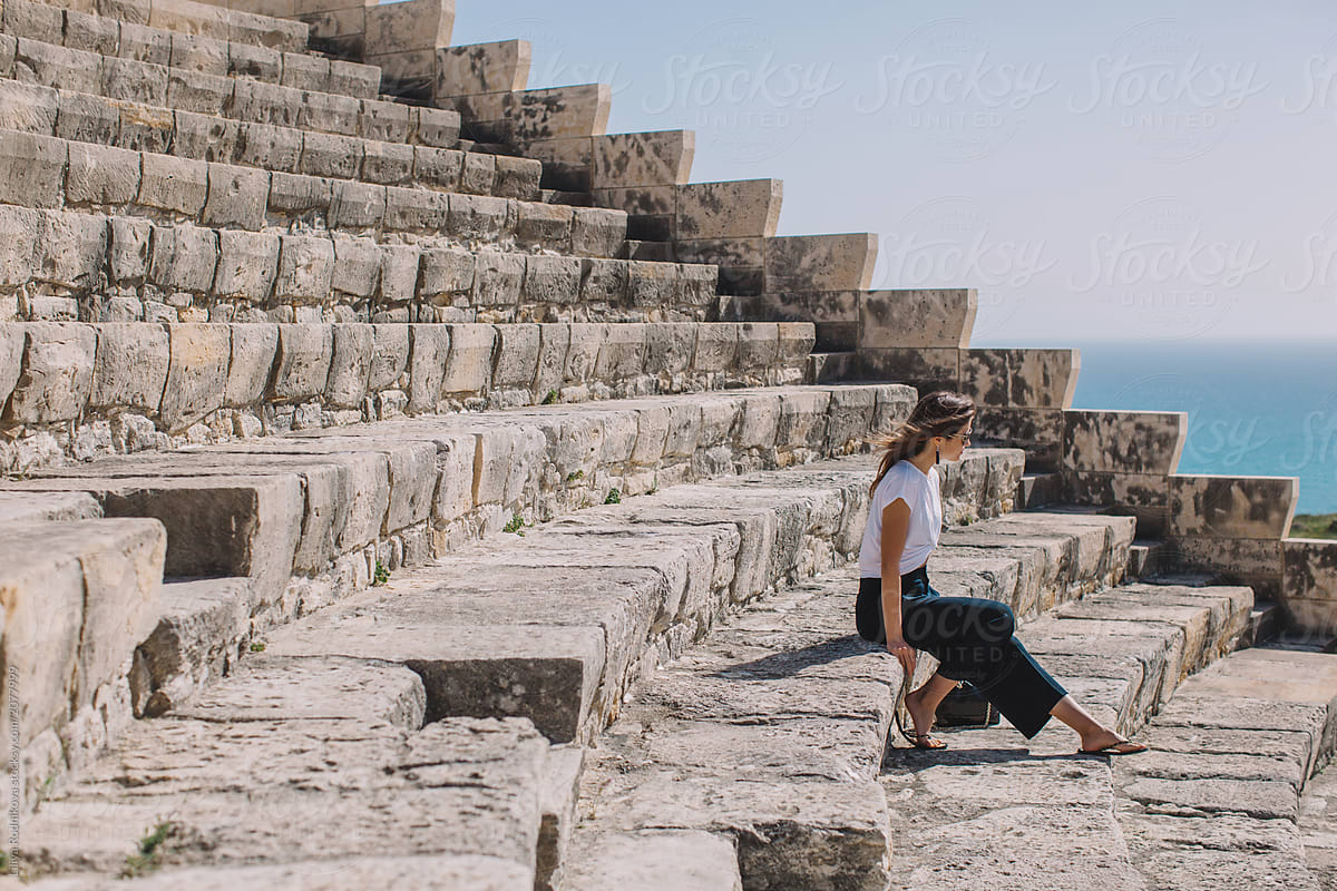 "Stylish Woman Sitting On Stairs Of Amphitheater" by Stocksy ...