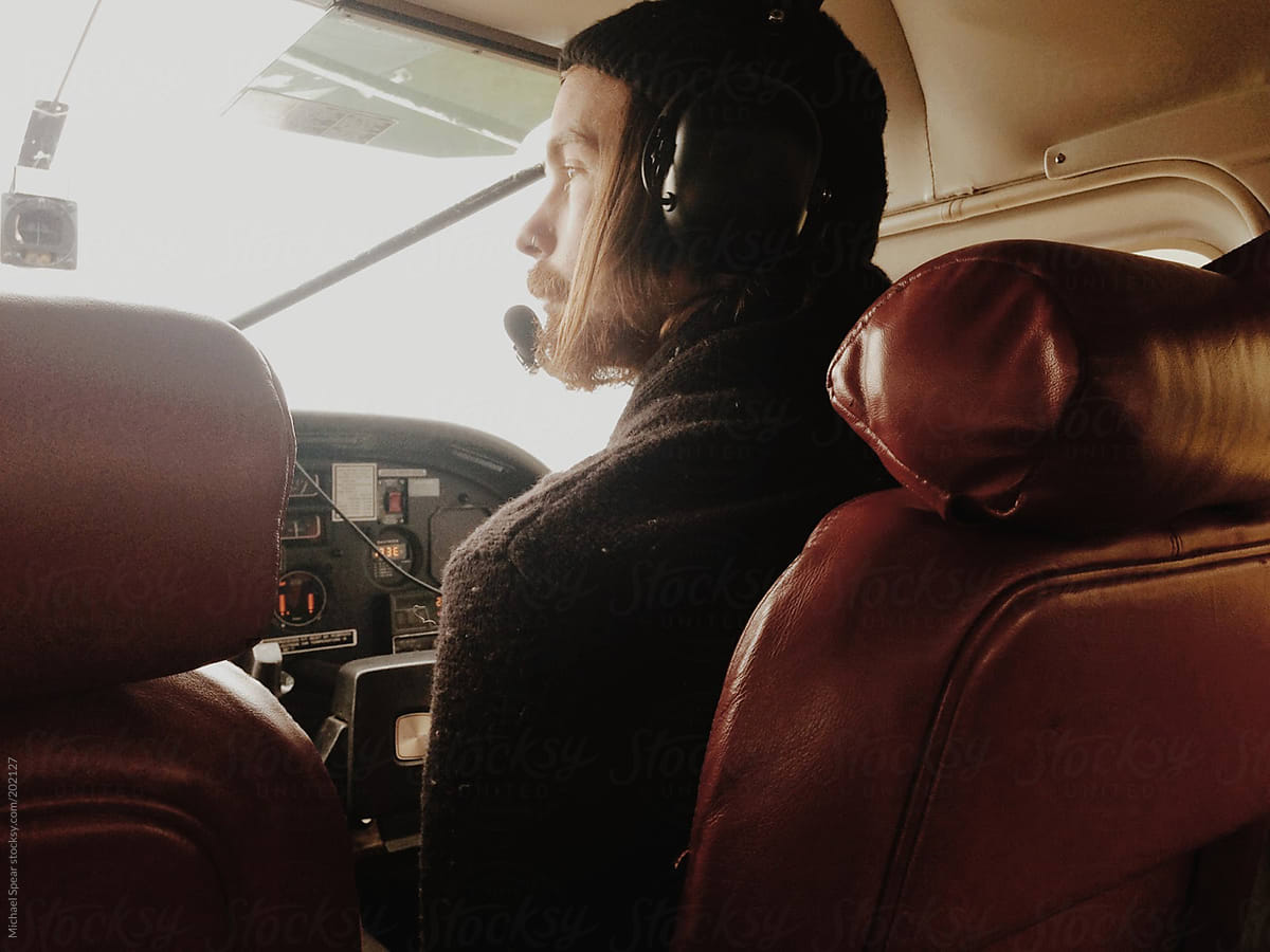 "Man Sitting In Plane" by Stocksy Contributor "Michael Spear" - Stocksy