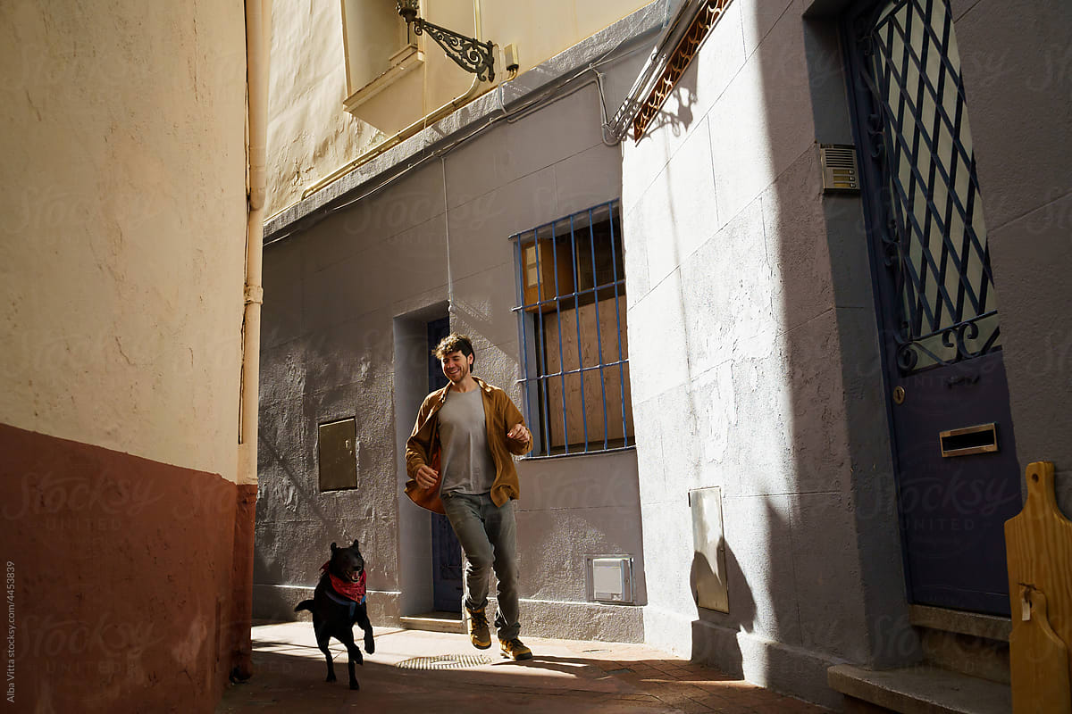 "Happy Confident Man Running With Dog In The City" by Stocksy ...