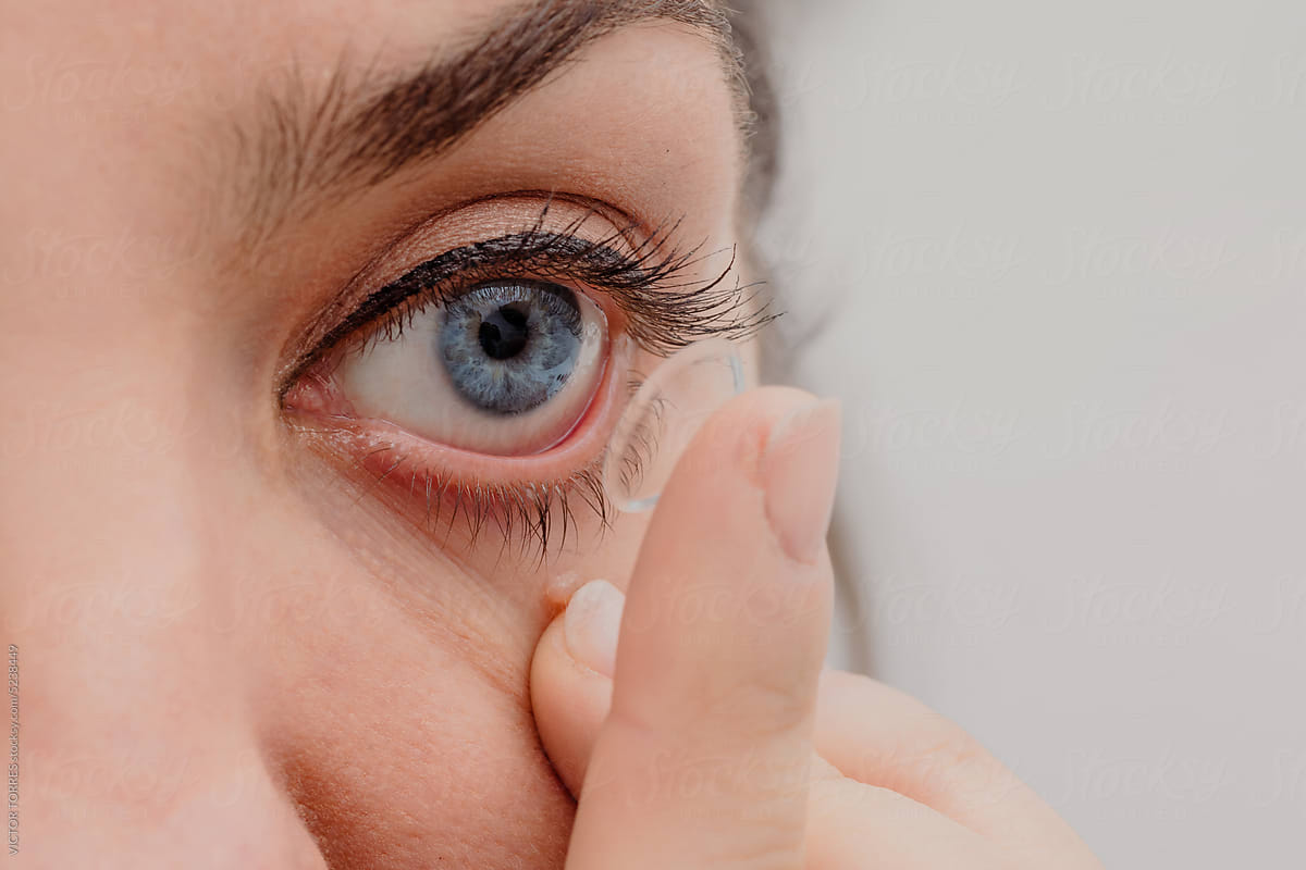 "Crop Woman Putting On Contact Lens" by Stocksy Contributor "VICTOR ...