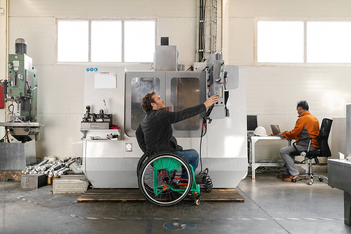 "Worker With A Disability Working With A Machine In The Factory" by ...