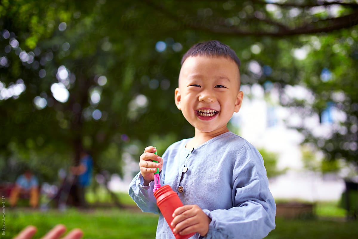 "Happy Asian Little Boy In The Park" by Stocksy Contributor "Bo Bo ...