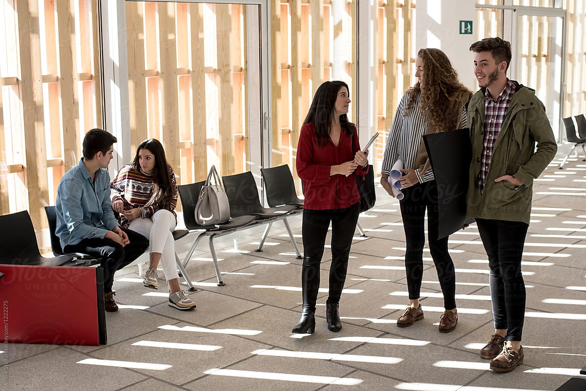 "Three Talking Students" by Stocksy Contributor "Bisual Studio" - Stocksy