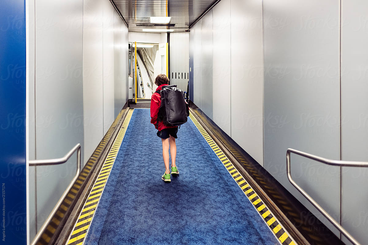 "Teenage Boy Viewed From Behind On An Aircraft Gangway" by Stocksy ...