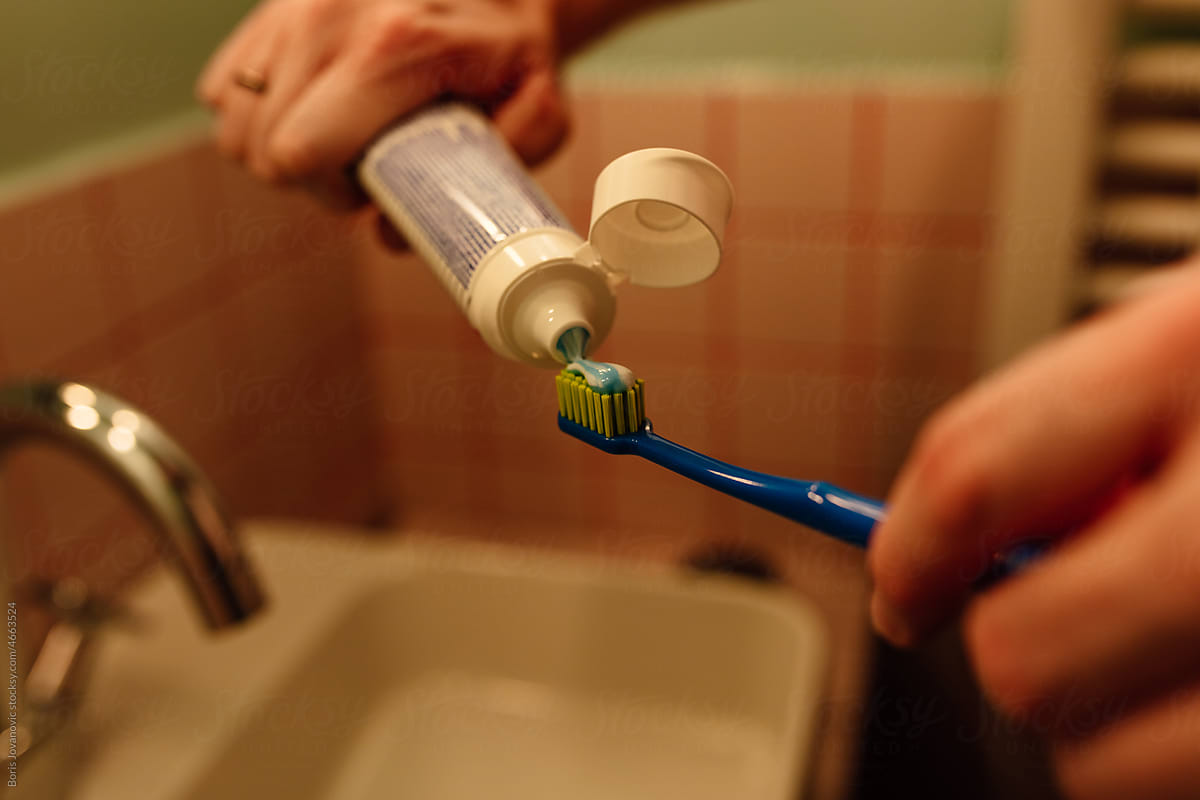 "Applying Toothpaste To The Brush" by Stocksy Contributor "Boris ...