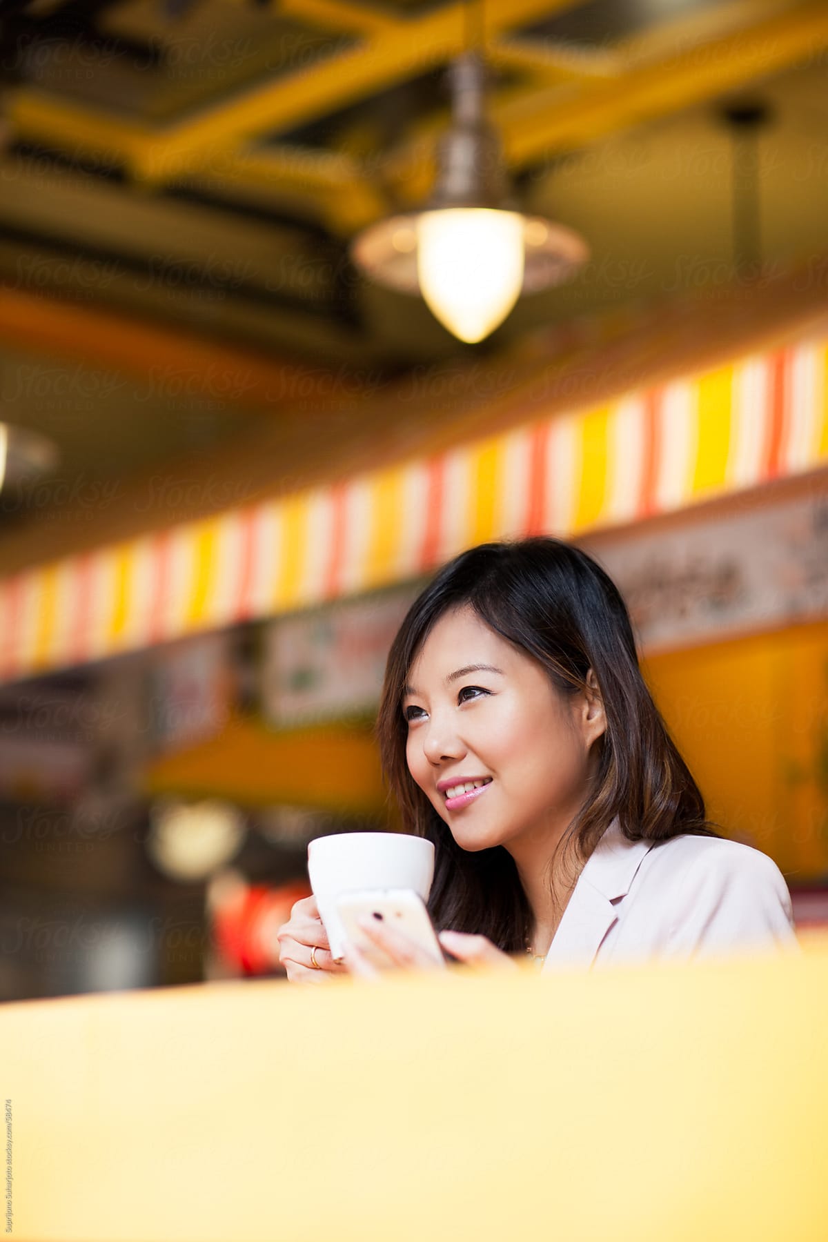 "Beautiful Asian Woman Holding A Coffee Cup Inside A Cafe" by Stocksy ...