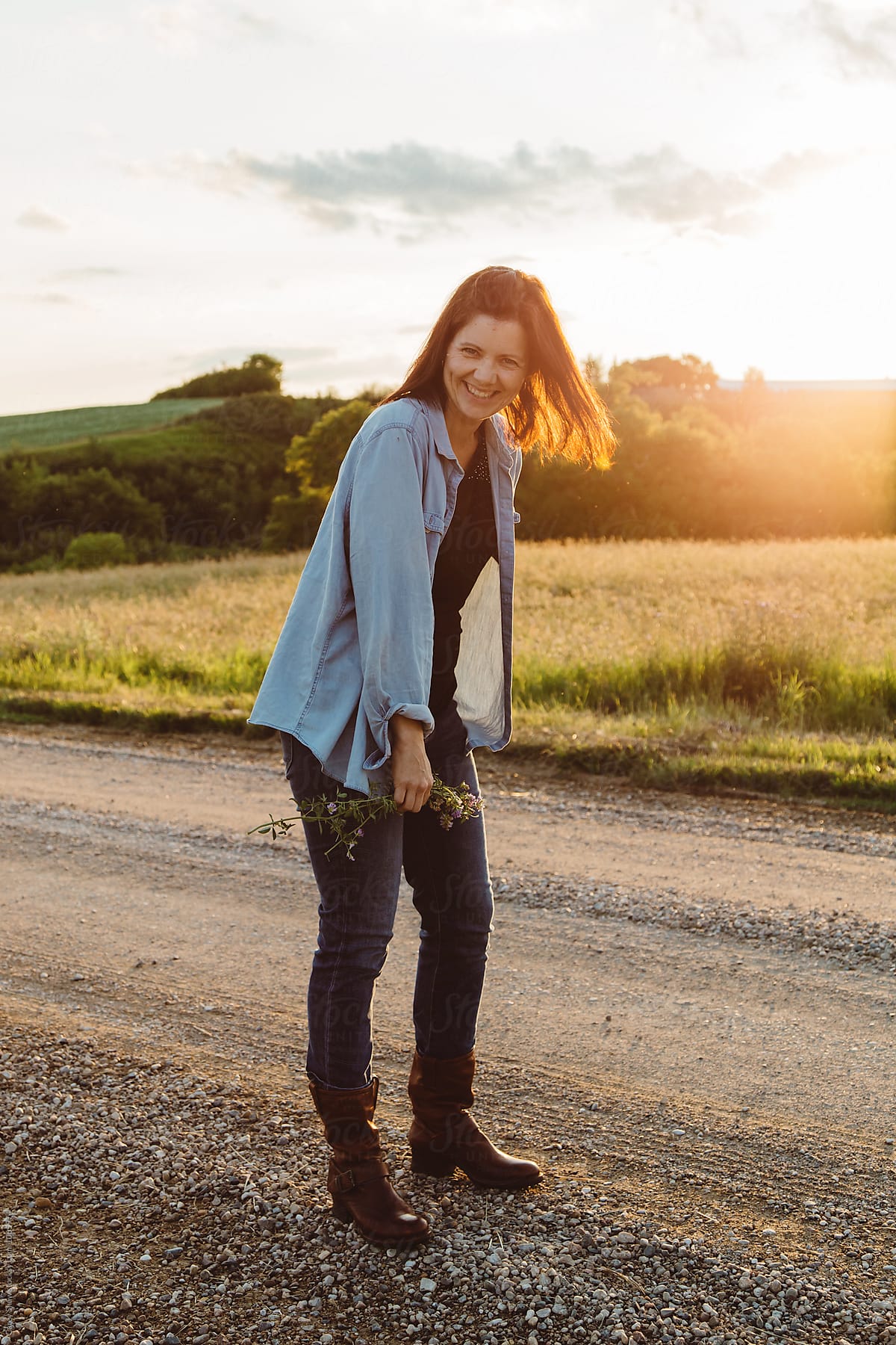 "Laughing Woman Standing On Countryside Road At Dusk" by Stocksy ...