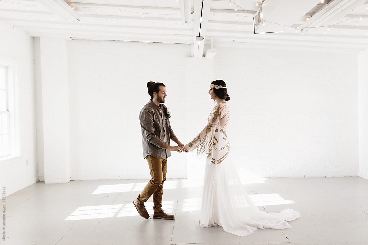 "Trendy Bride And Groom Face Each Other In White Room" by Stocksy ...