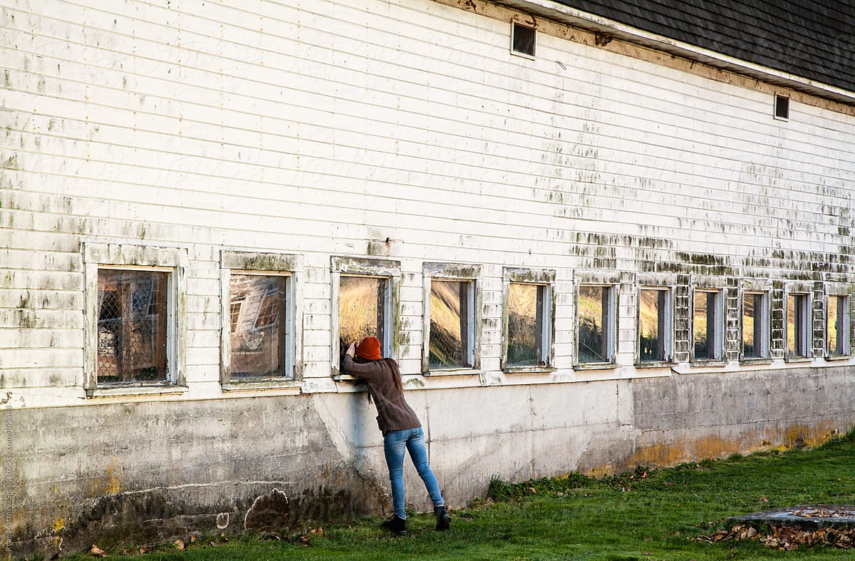 "Girl Peeking Into Barn" by Stocksy Contributor "Ryan Matthew Smith ...