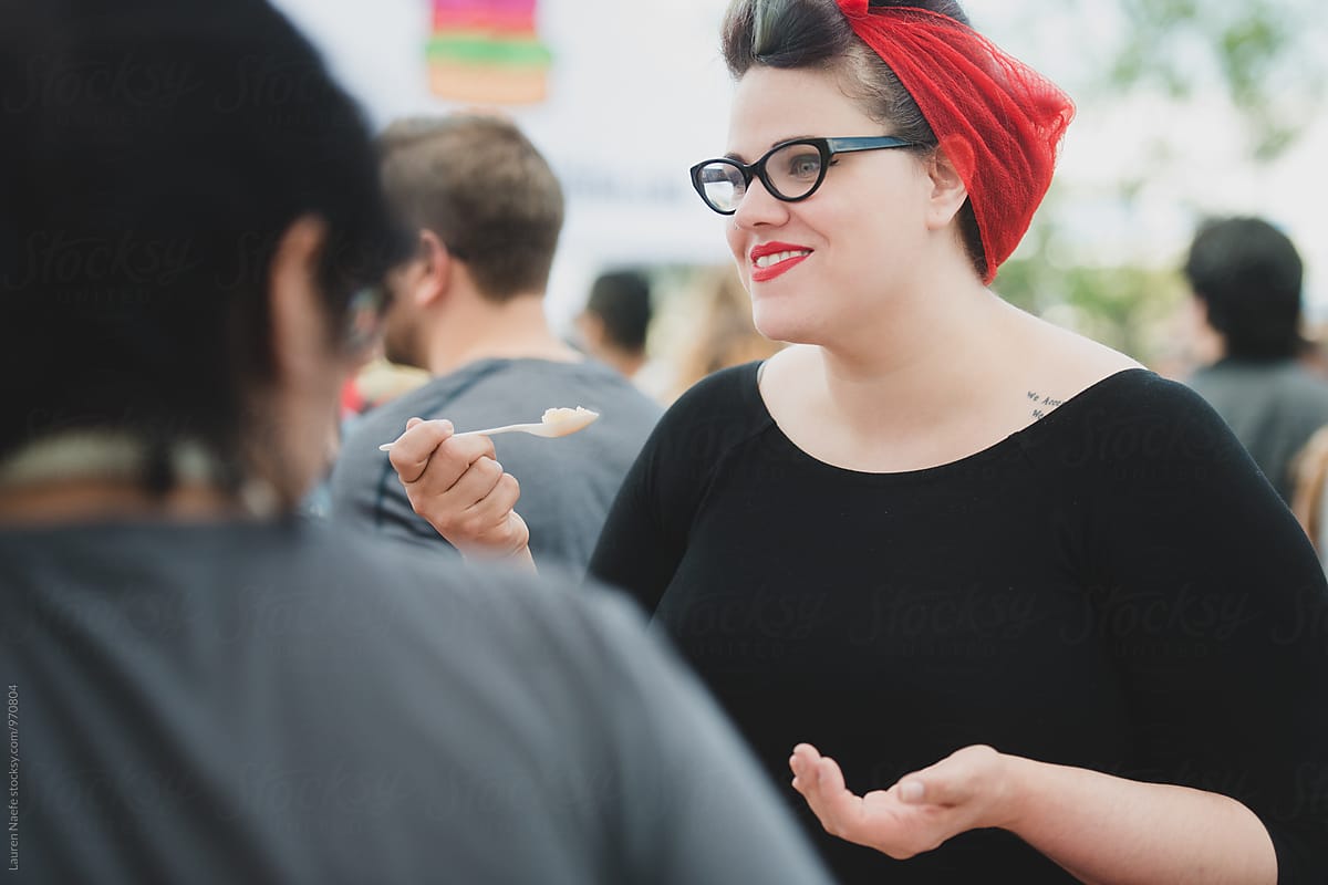 "Woman Tasting Food At Food Cart" by Stocksy Contributor "Lauren Lee ...