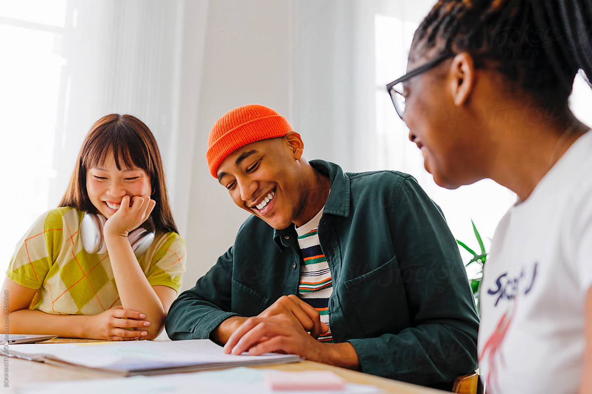 "Students Sharing Laughter And Ideas While Doing Homework Together" by ...