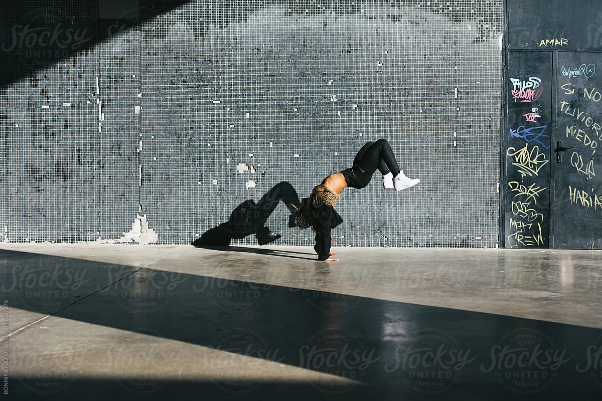 "Young African American Woman Performing Break Dance In A City." by ...