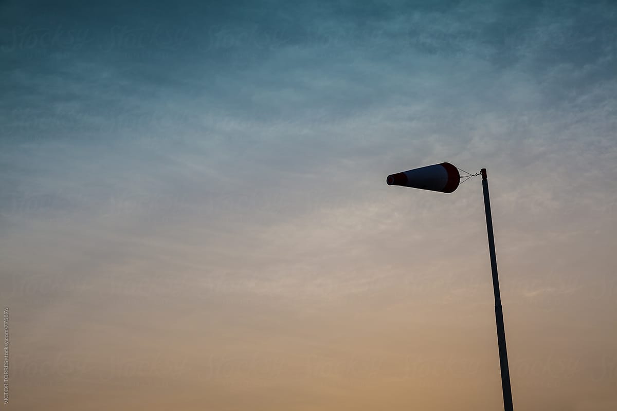 "Windsock At Sunset" by Stocksy Contributor "VICTOR TORRES" - Stocksy