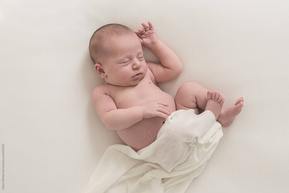 "A Curled Up Newborn Baby Sleeping" by Stocksy Contributor "Alison ...