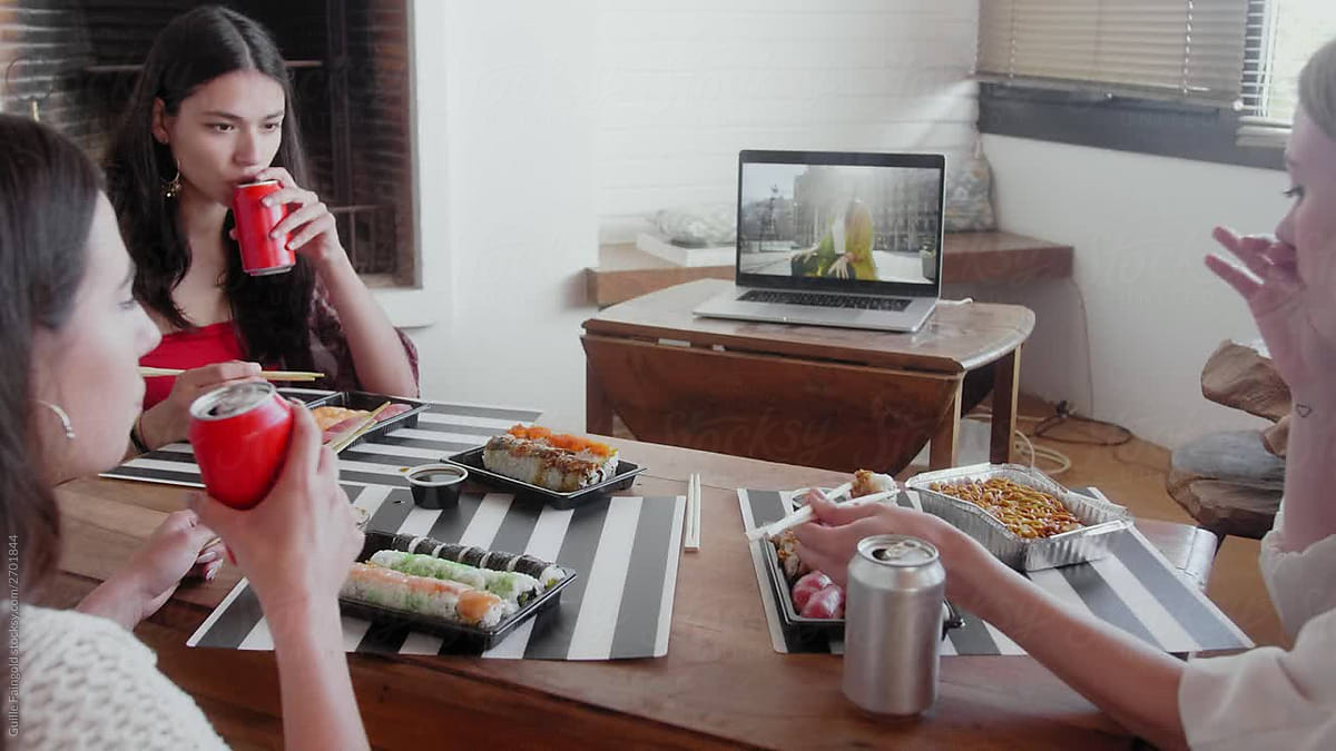 "Friends Watching Video And Eating" by Stocksy Contributor "Guille ...
