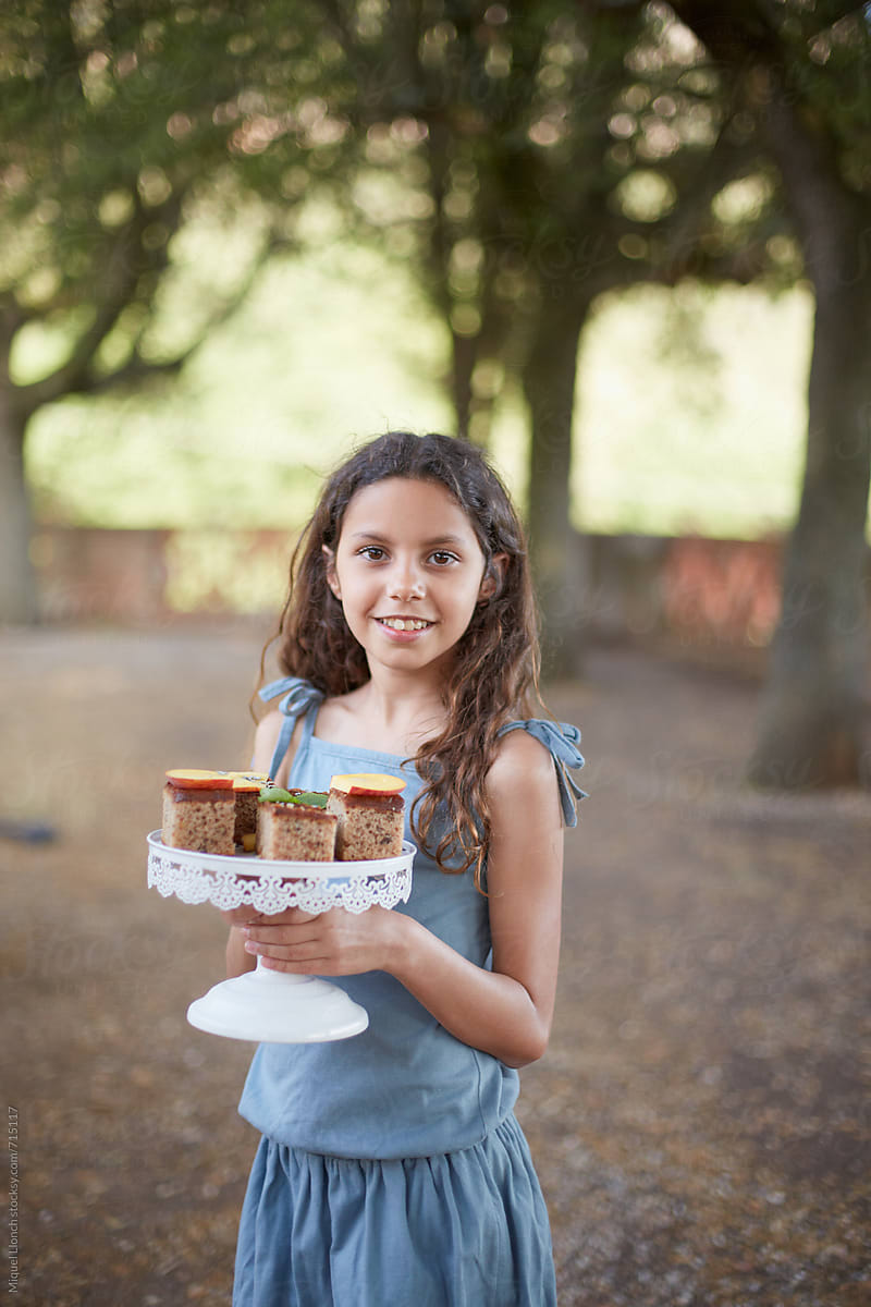 "Young Girl Holding A Plate With Cakes" by Stocksy Contributor "Miquel ...