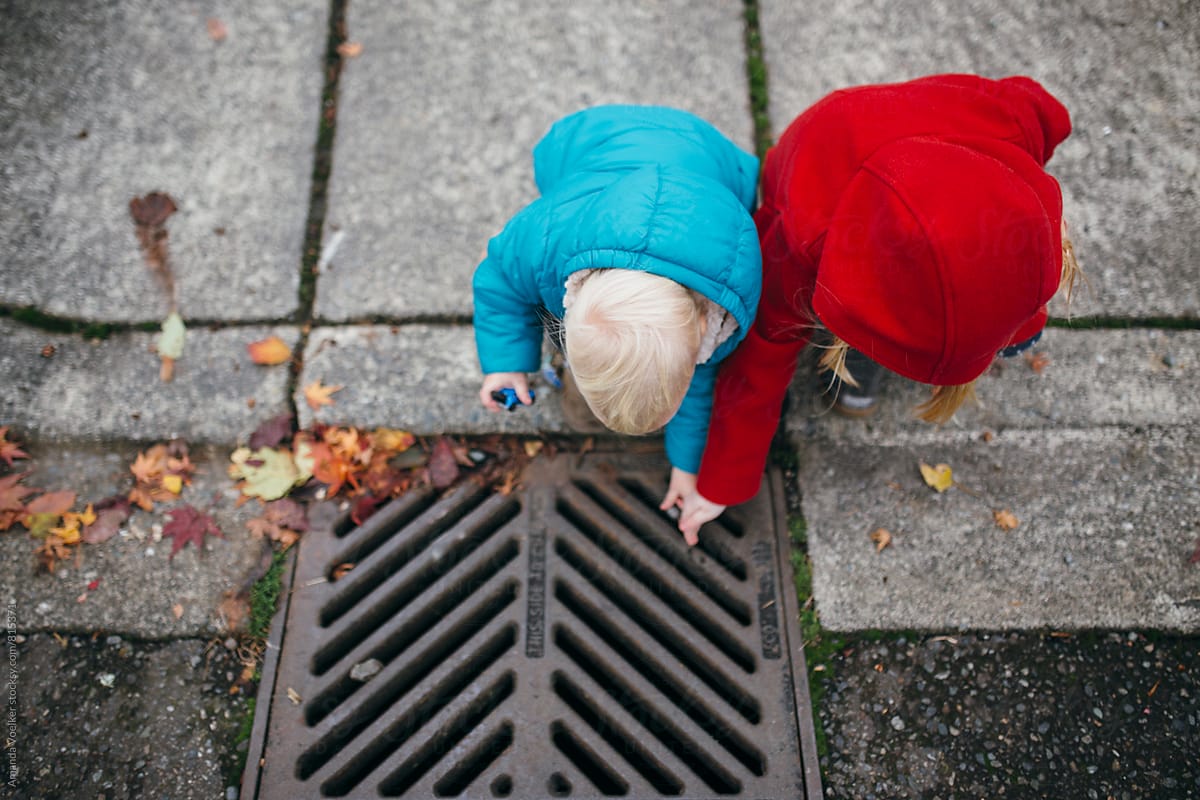 "Birds Eye View Of Two Young Children On The Sidewalk In Bright Coats ...
