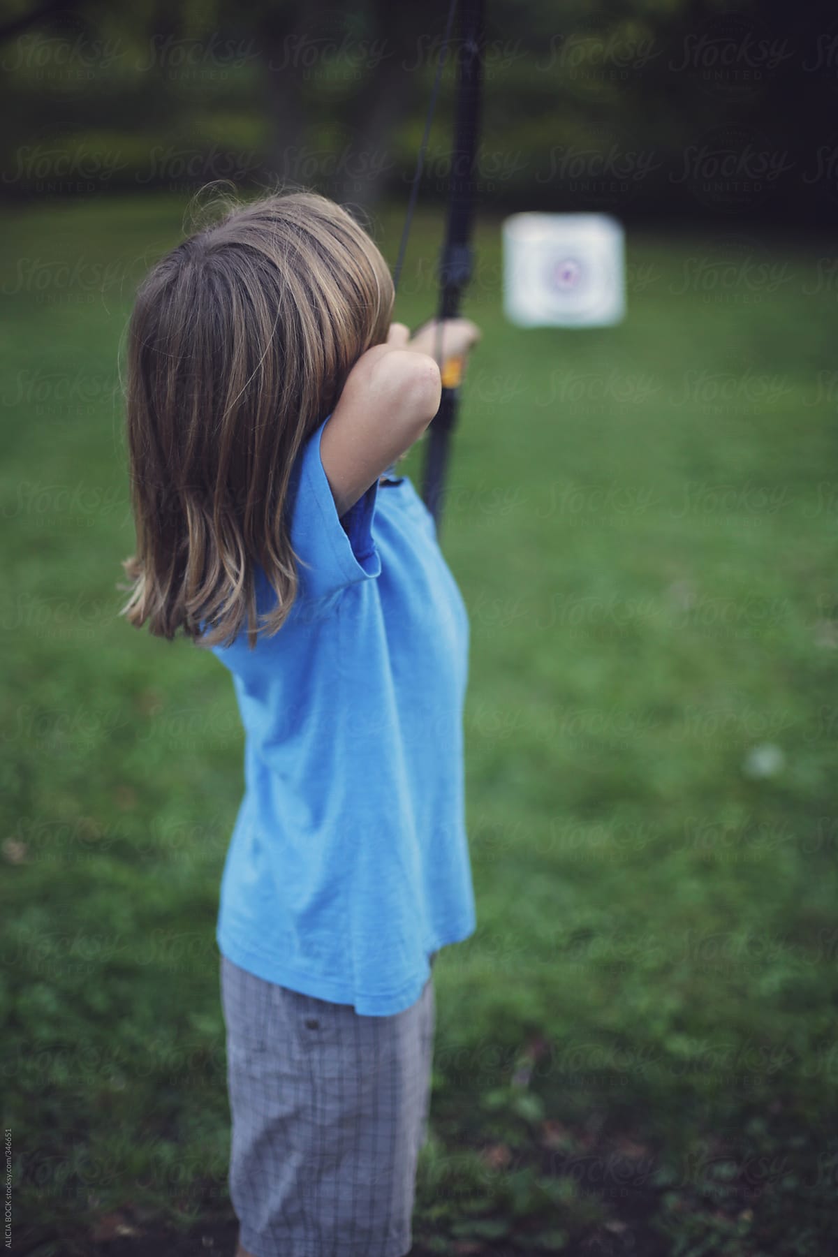 "A Boy Aiming A Bow At A Target" by Stocksy Contributor "ALICIA BOCK ...