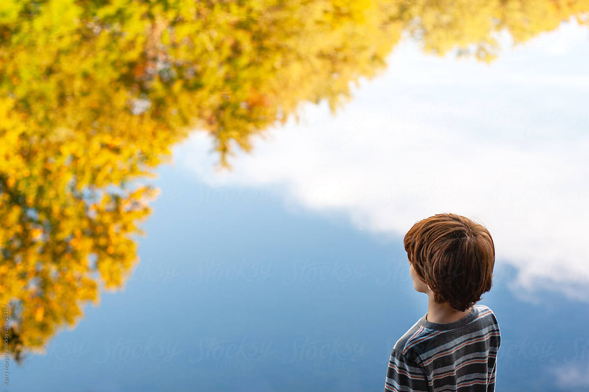 "Boy By Lake With Tree Reflection" by Stocksy Contributor "Kerry Murphy ...
