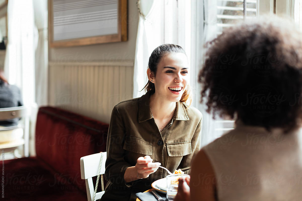 "Cheerful Woman Communicating With Friend During Lunch" by Stocksy ...
