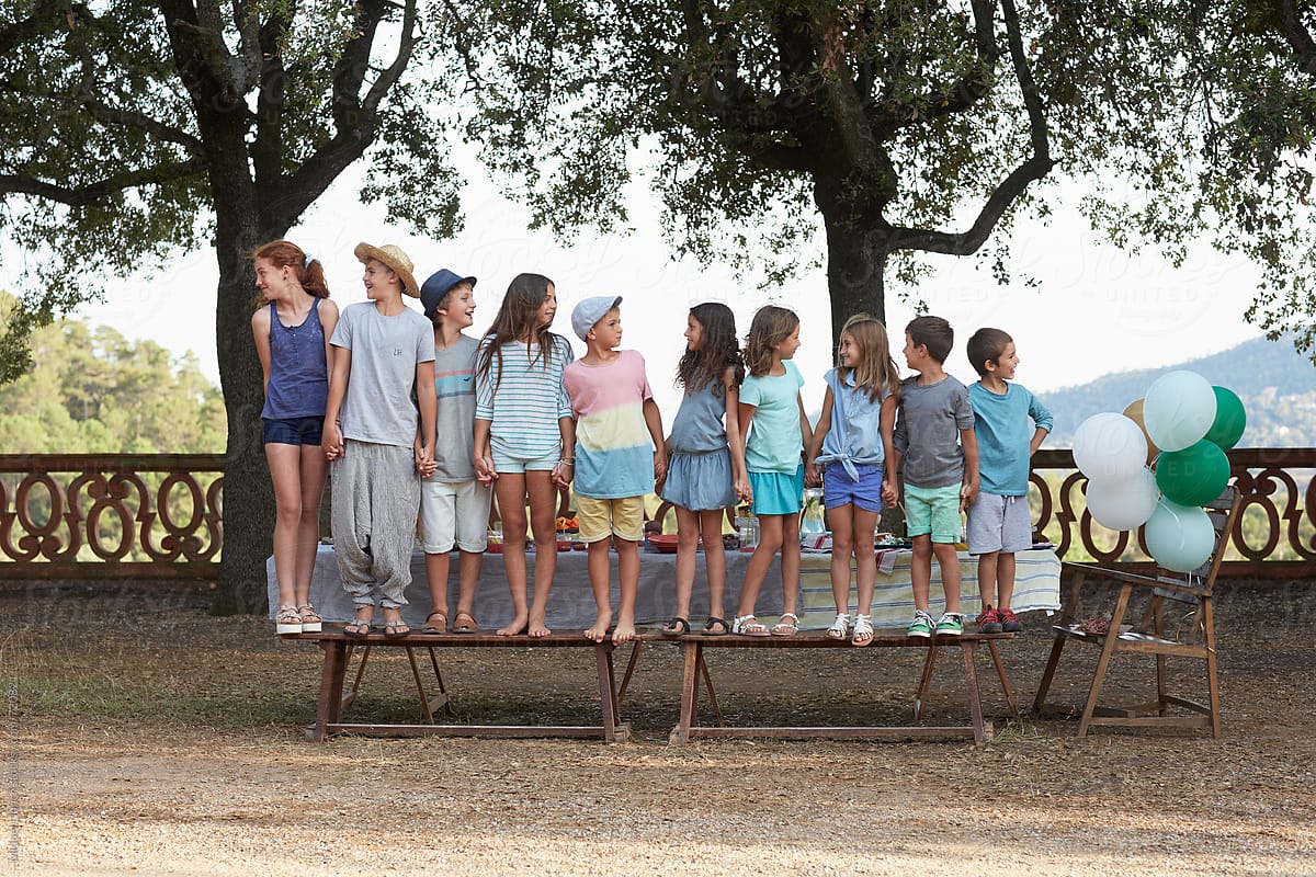 "Group Portrait Of Ten Children Holding Hands And Looking At Each Other ...