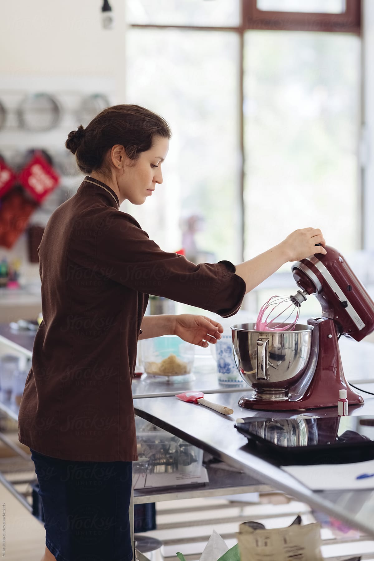 "Woman Making Pink Dough" by Stocksy Contributor "Milles Team" - Stocksy