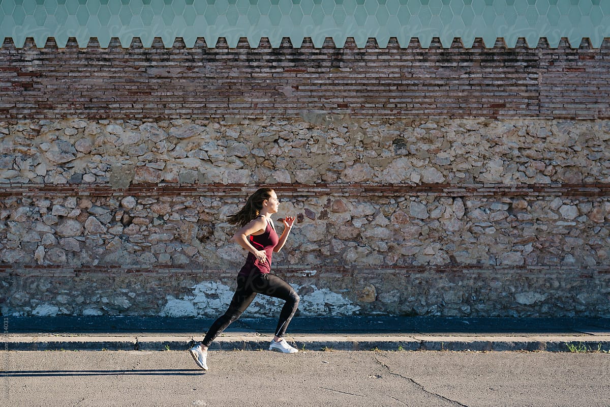 "Side View Of Woman Running" by Stocksy Contributor "Javier Díez" - Stocksy