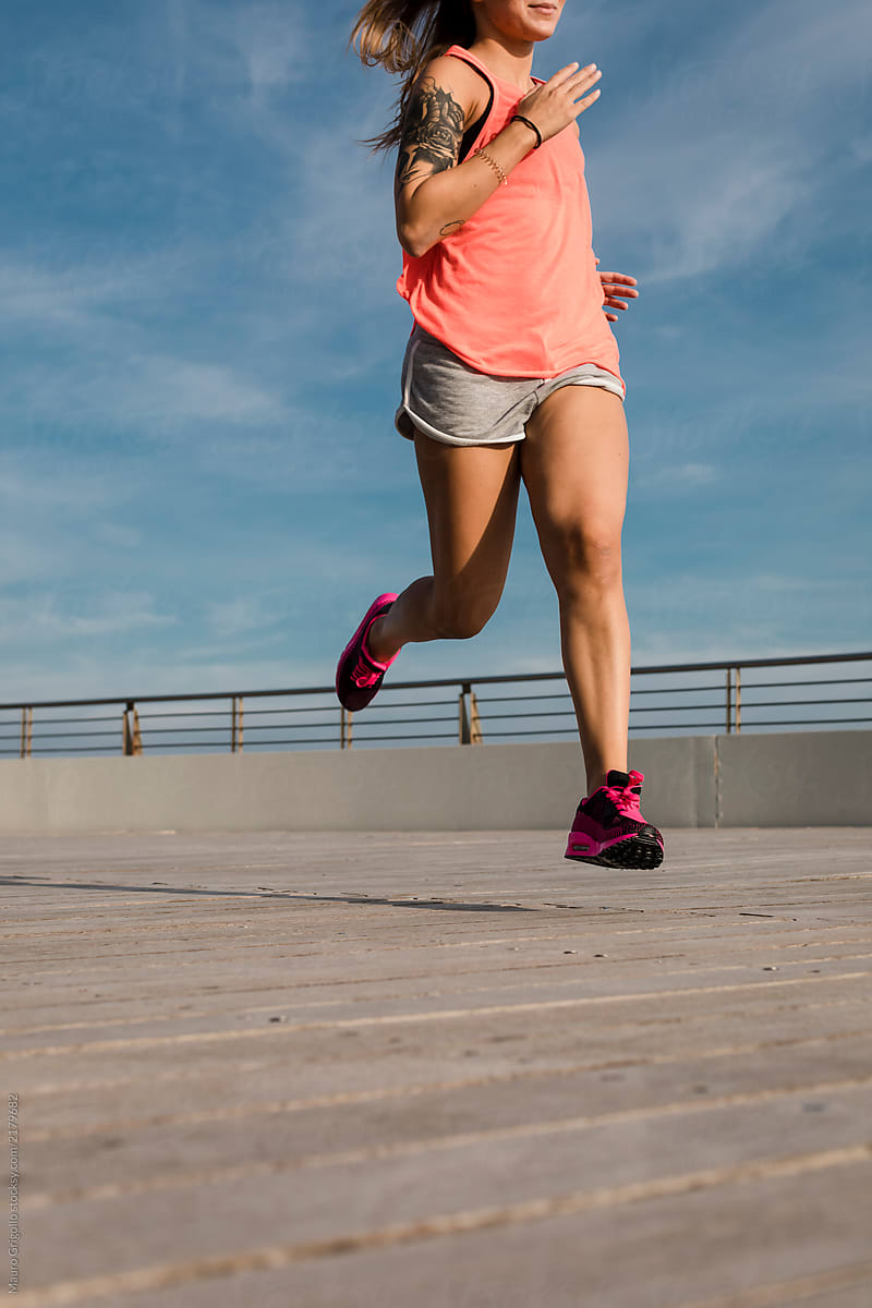 "Woman Runs Outdoor" by Stocksy Contributor "Mauro Grigollo" - Stocksy